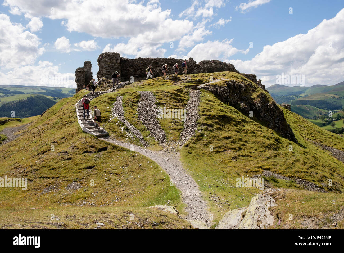 Walkers on path to 13th century Castell Dinas Bran castle remains on ...