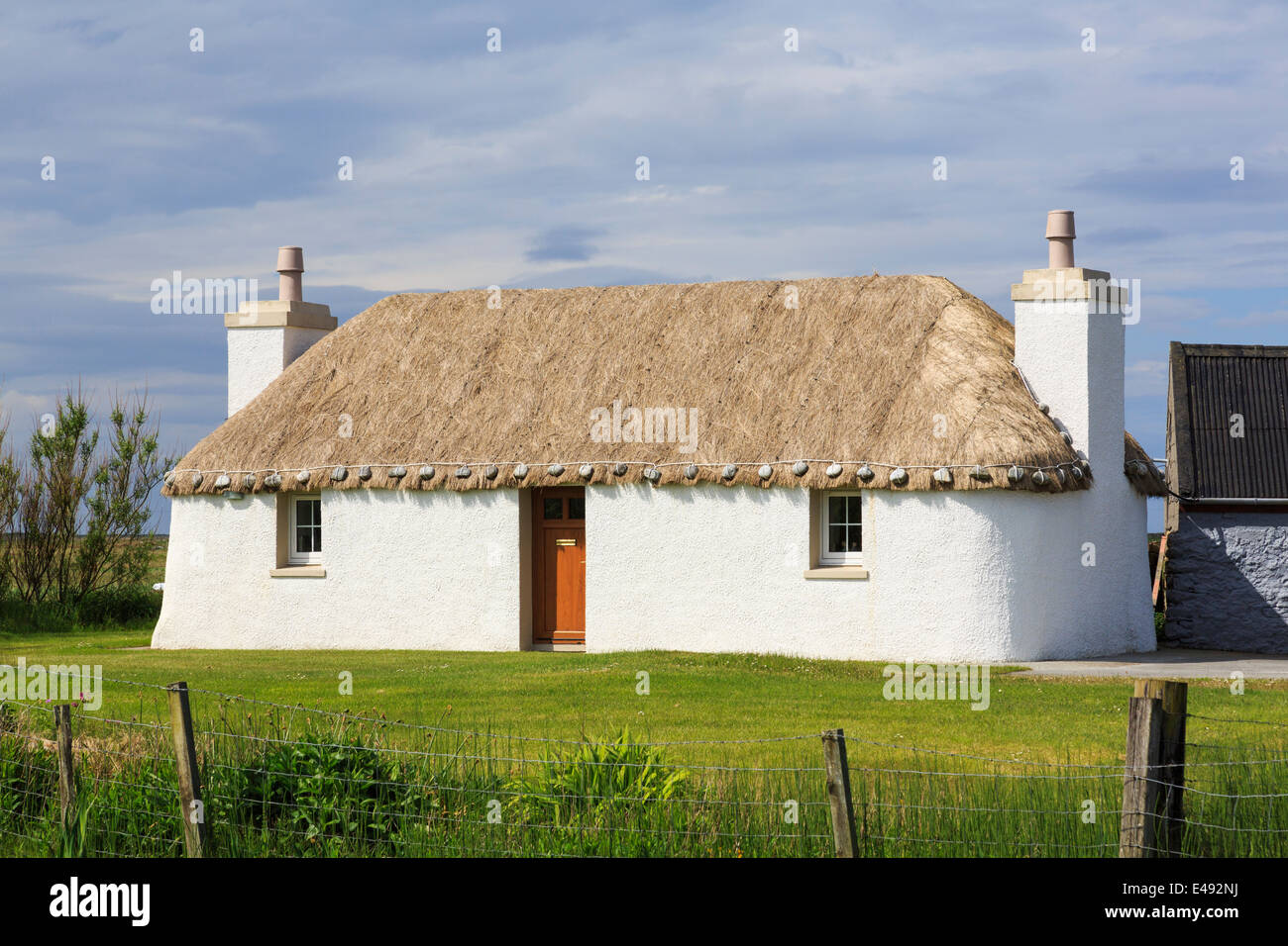 Old restored thatched croft cottage with traditional limewashed walls ...