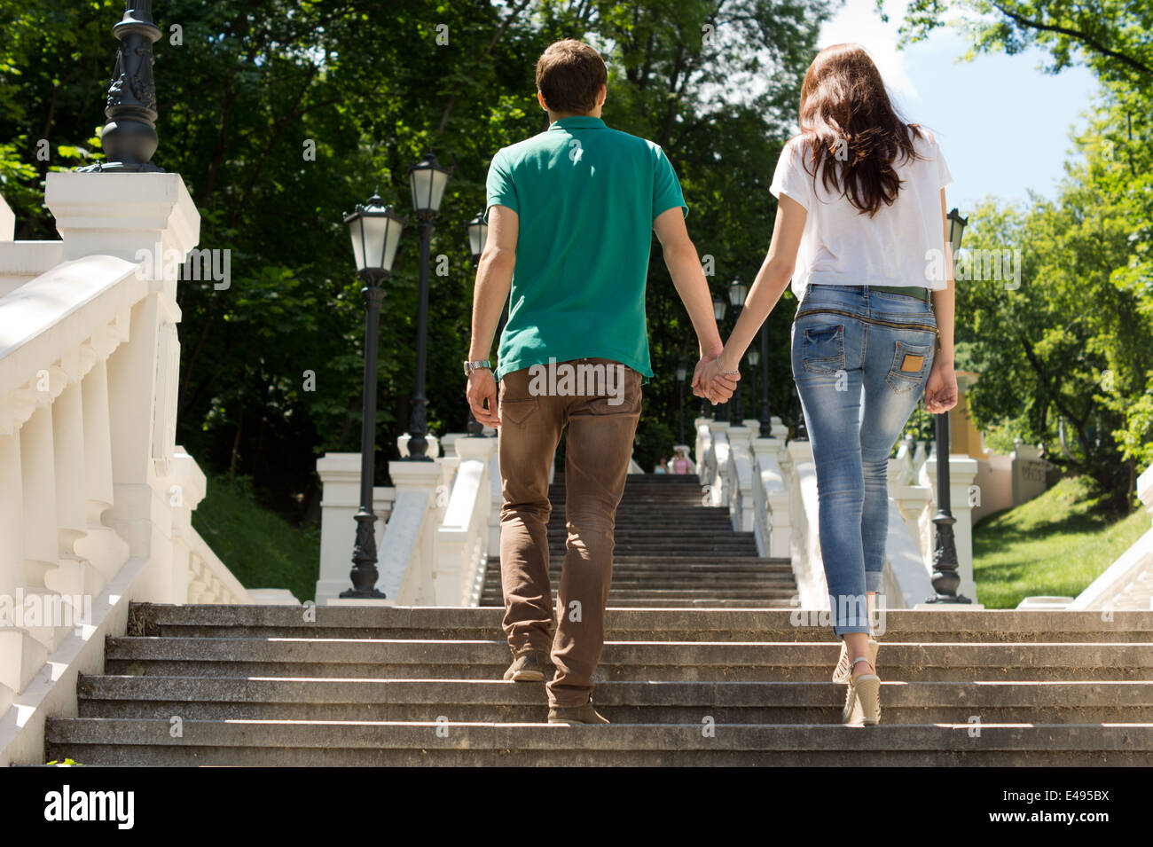 With a young couple walking away from camera hi-res stock photography ...