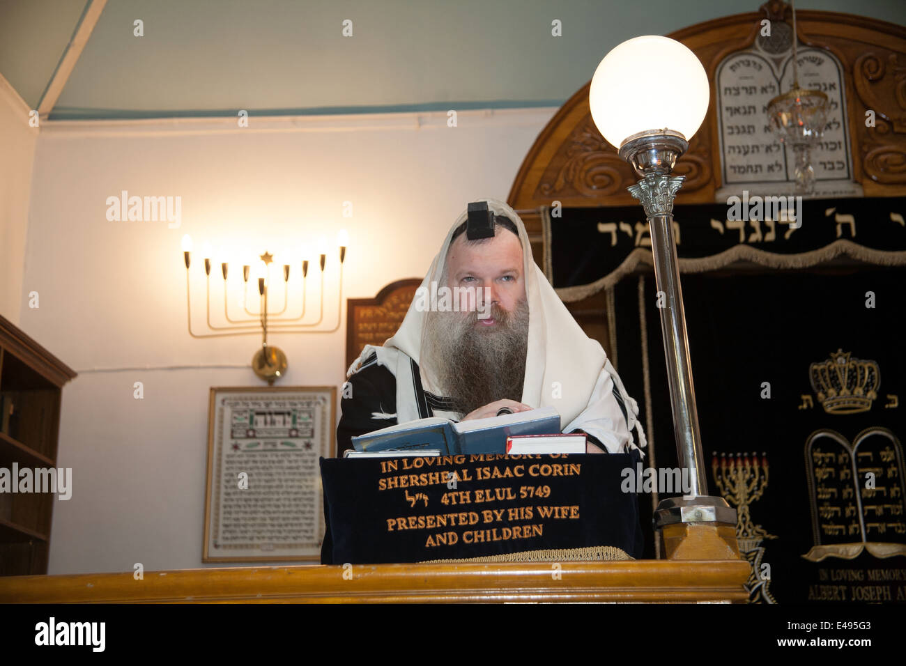 Rabbi reading The Megillah "The Scroll of Esther" during the Jewish ...