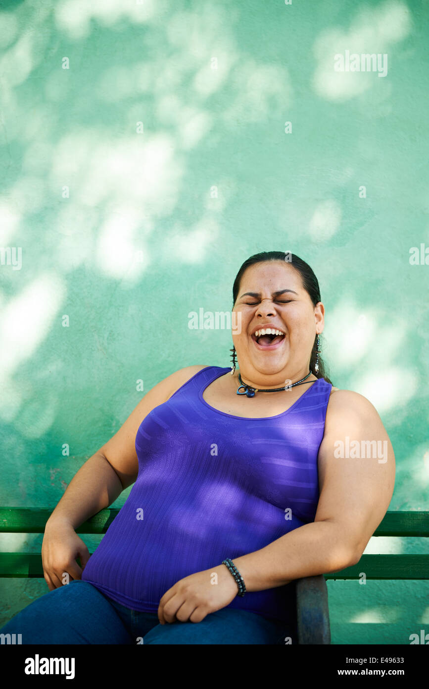 Portrait of overweight hispanic woman looking at camera and smiling ...