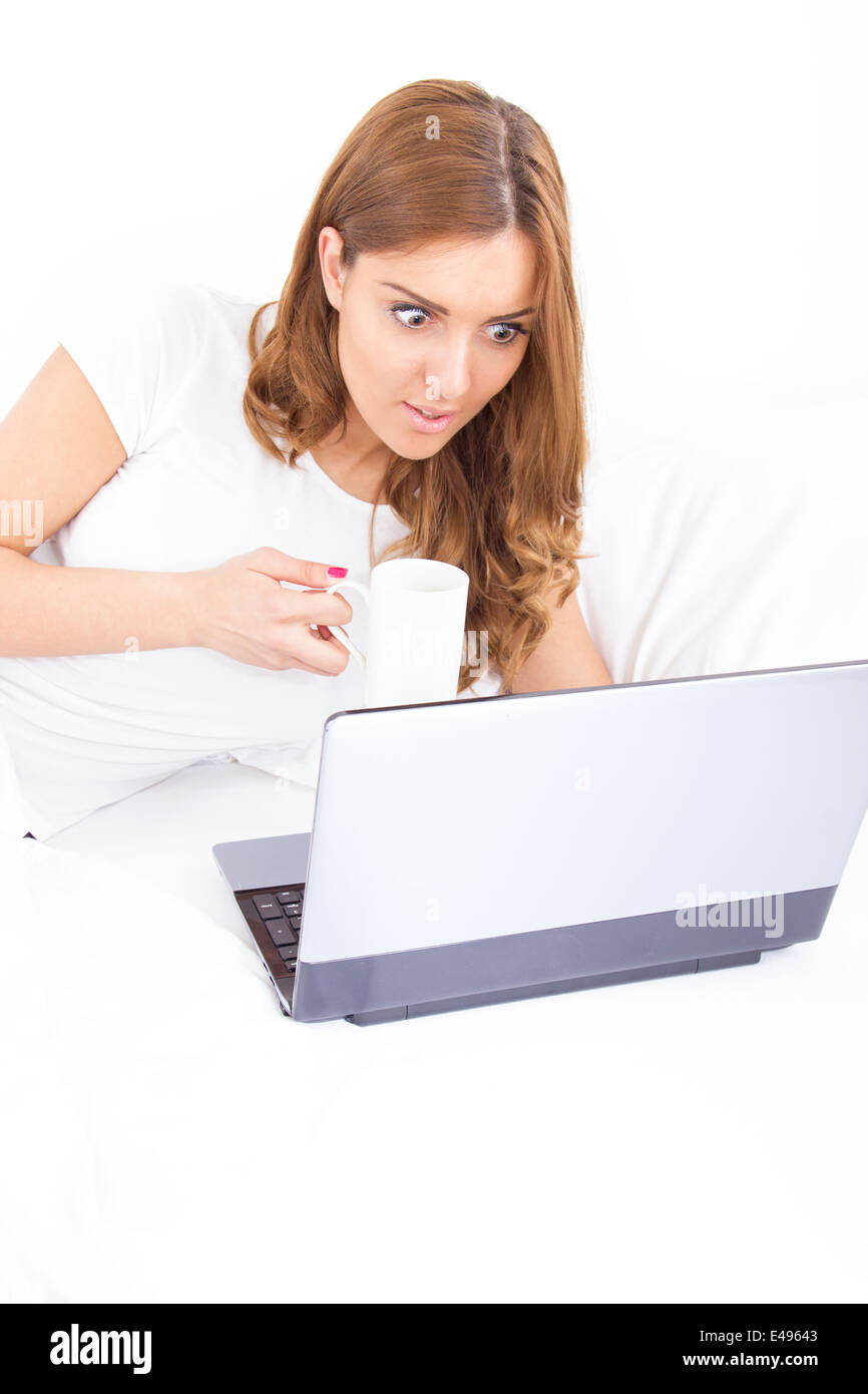 portrait of confused and surprised young woman reading a message on ...