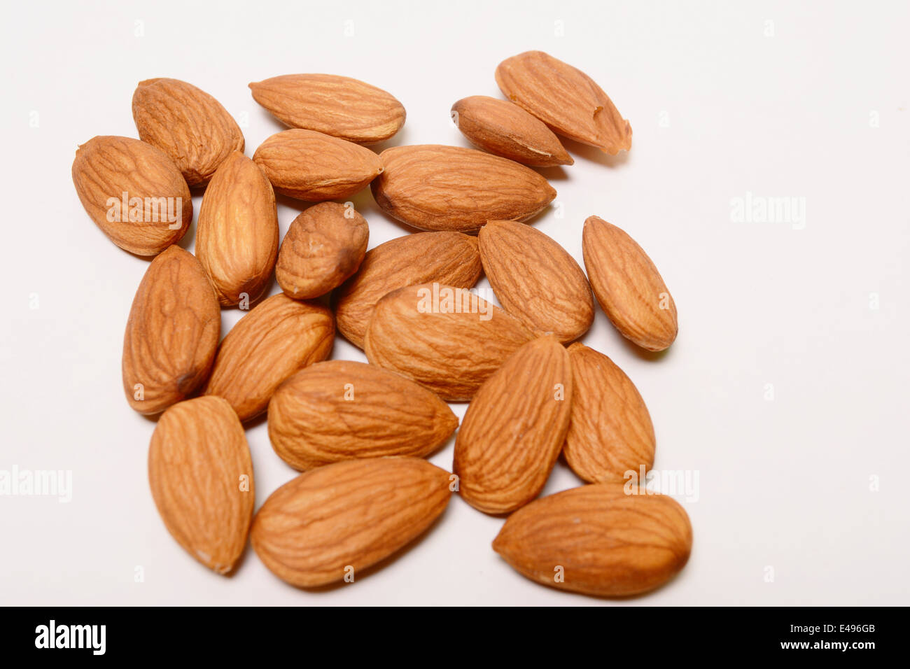 Unshelled almonds on a white background Stock Photo - Alamy