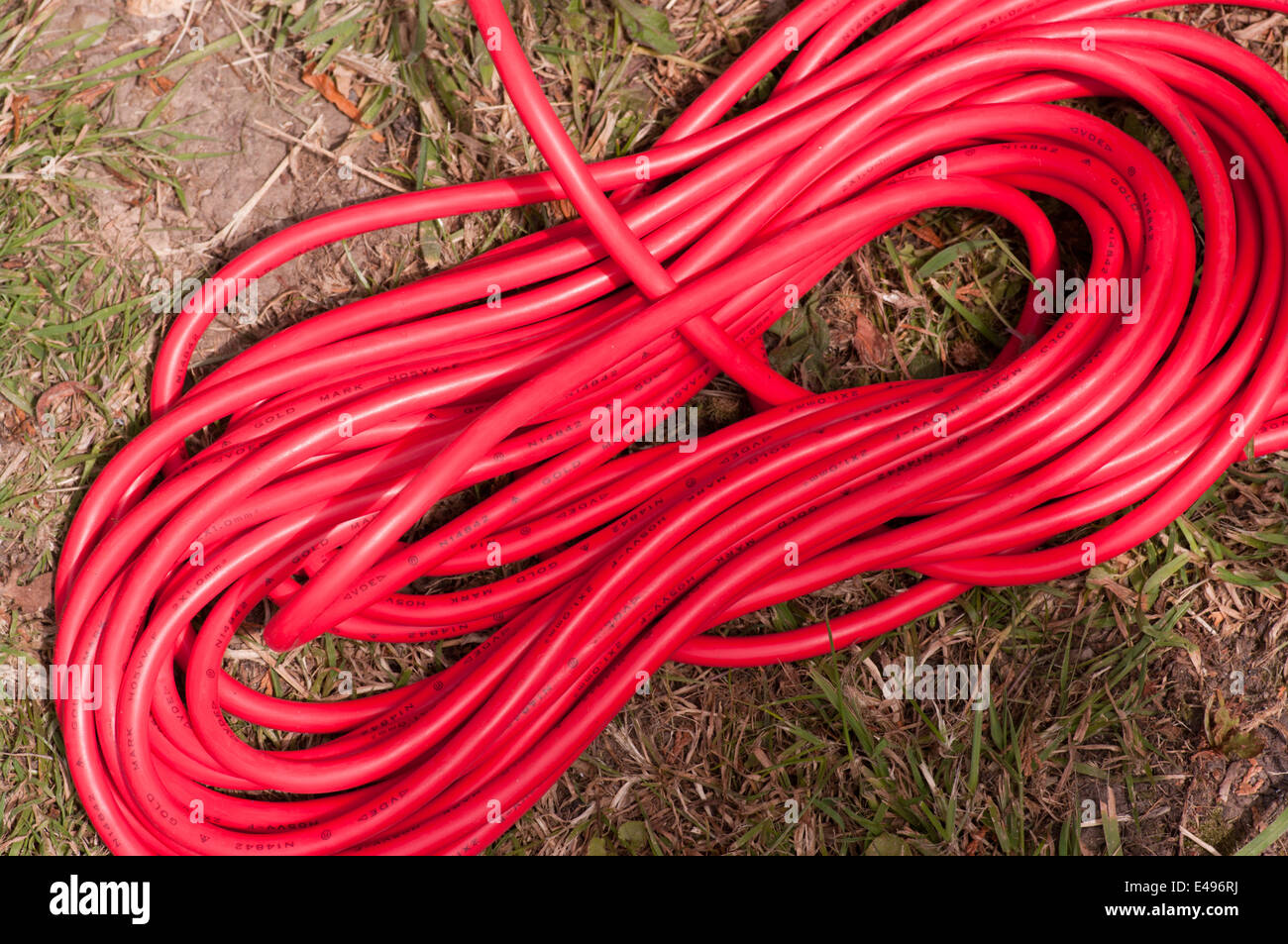 Coiled Garden Electric Red Cable Electrical Cables Stock Photo - Alamy