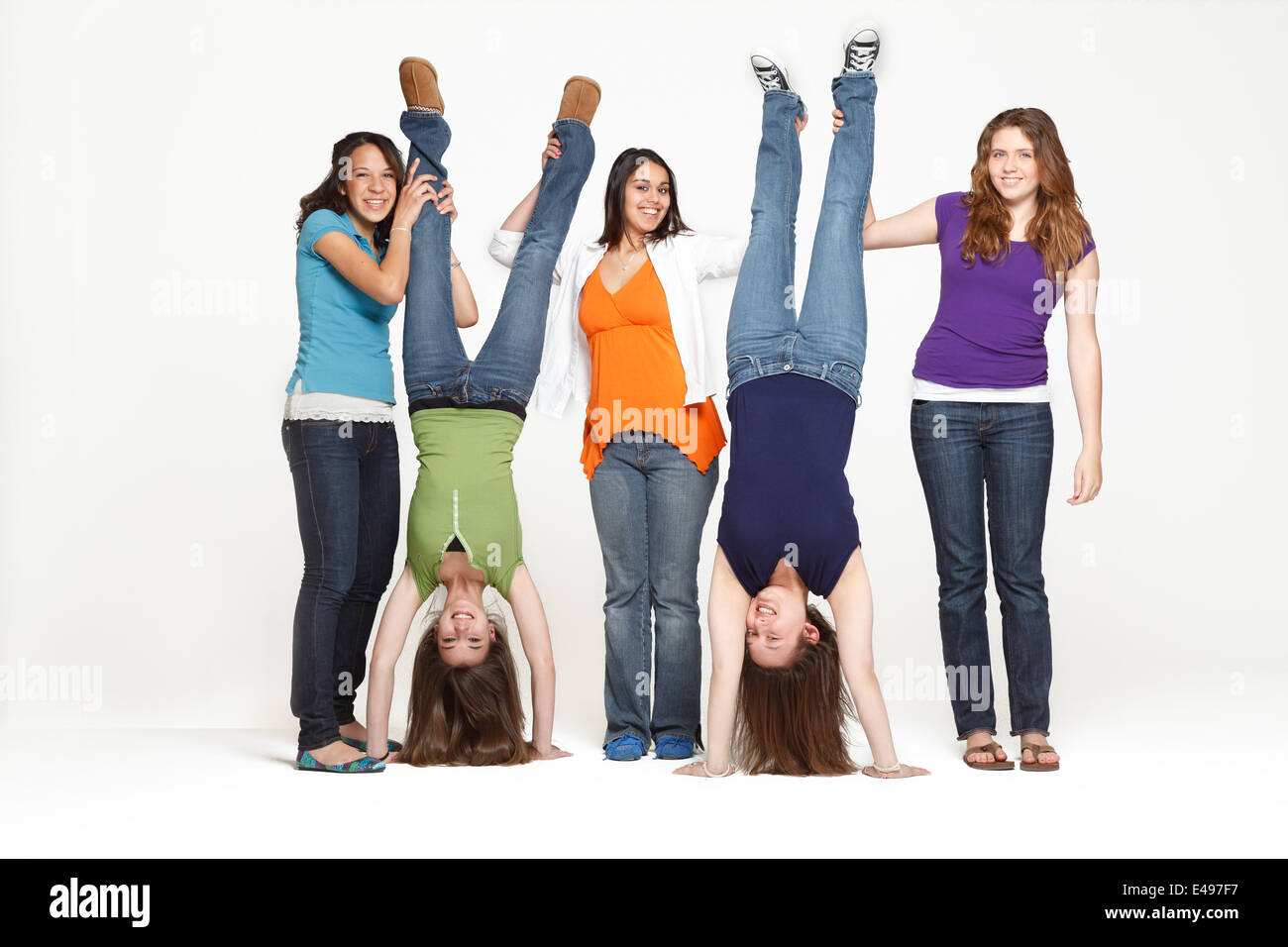 a group of five girls having fun and doing hand stands Stock Photo - Alamy