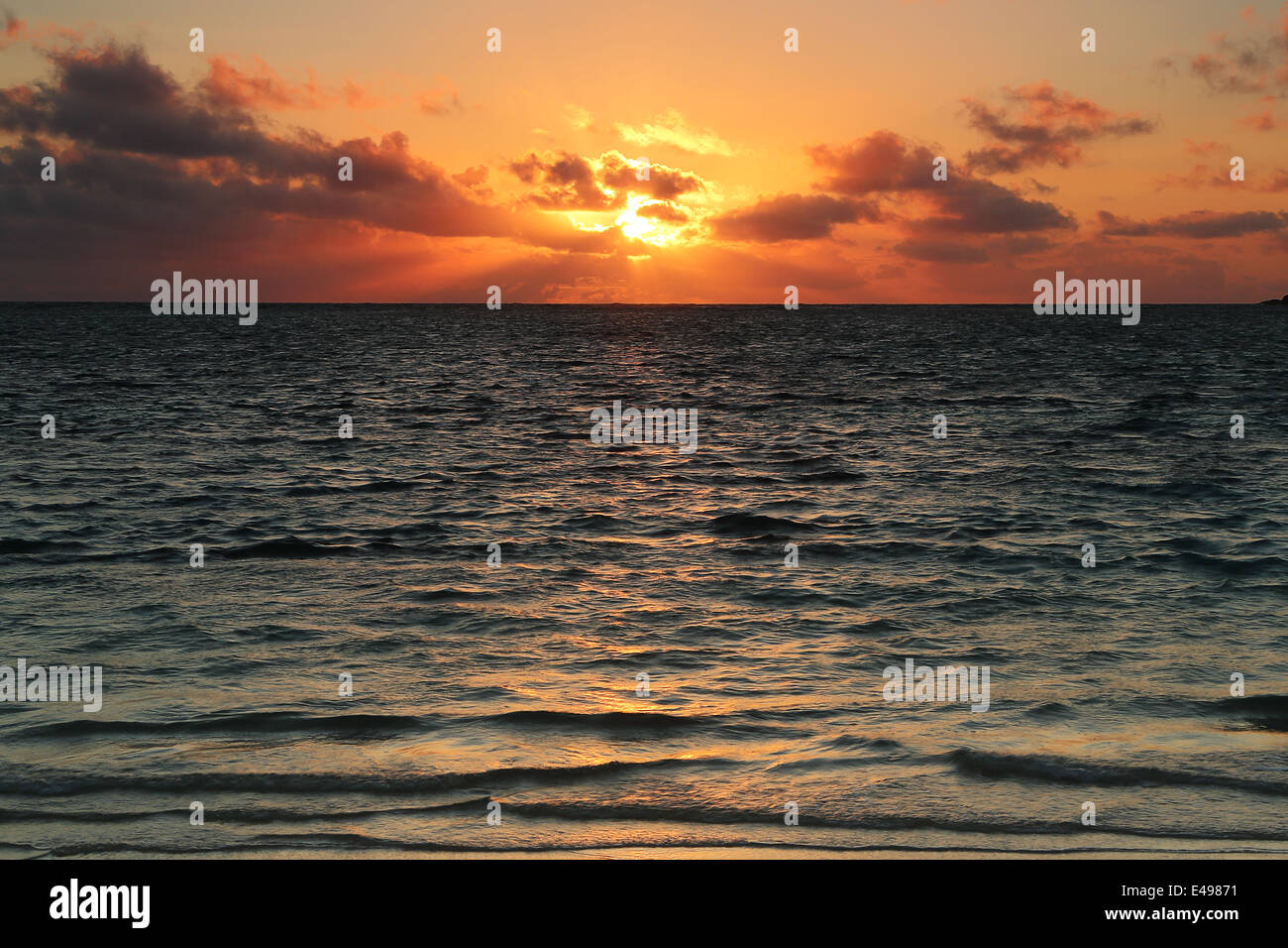 Sunrise over the beautiful blue ocean on the island of Oahu, Hawai'i ...