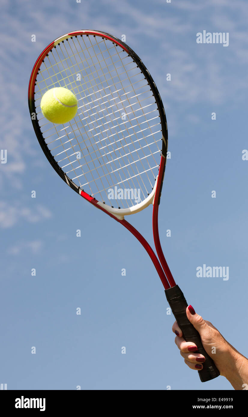 Tennis racquet and ball against blue sky Stock Photo - Alamy