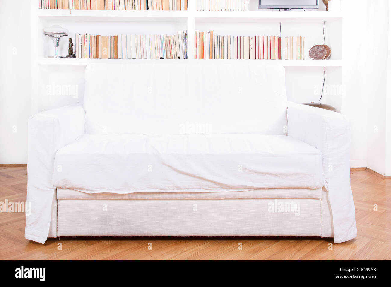 Home library with sofa or couch. Clean and modern decoration, white ...