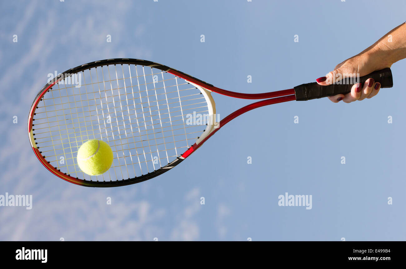 Tennis racquet and ball against blue sky Stock Photo - Alamy