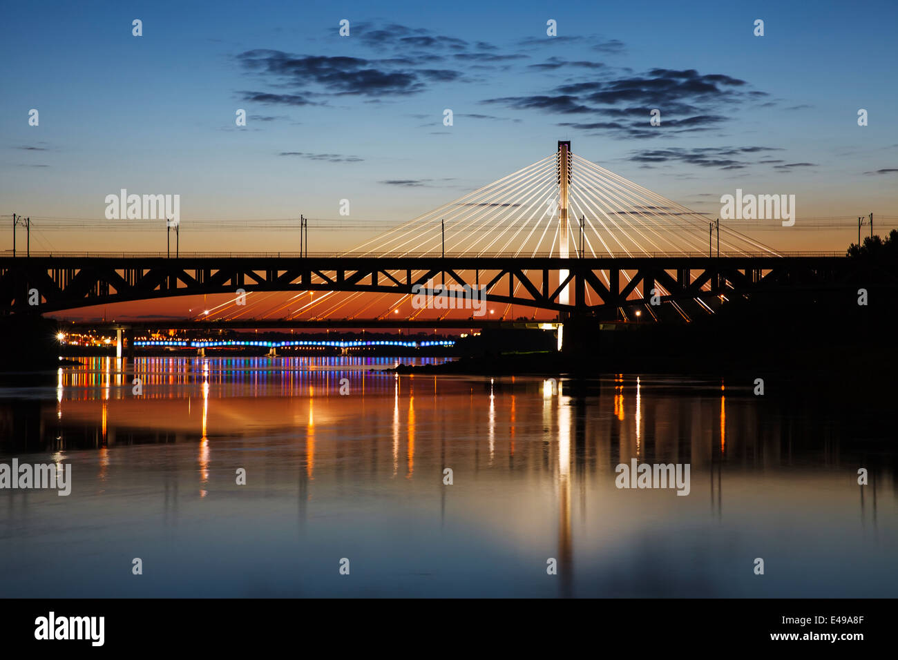 Backlit bridge at night and reflected in the water. Swietokrzystki ...