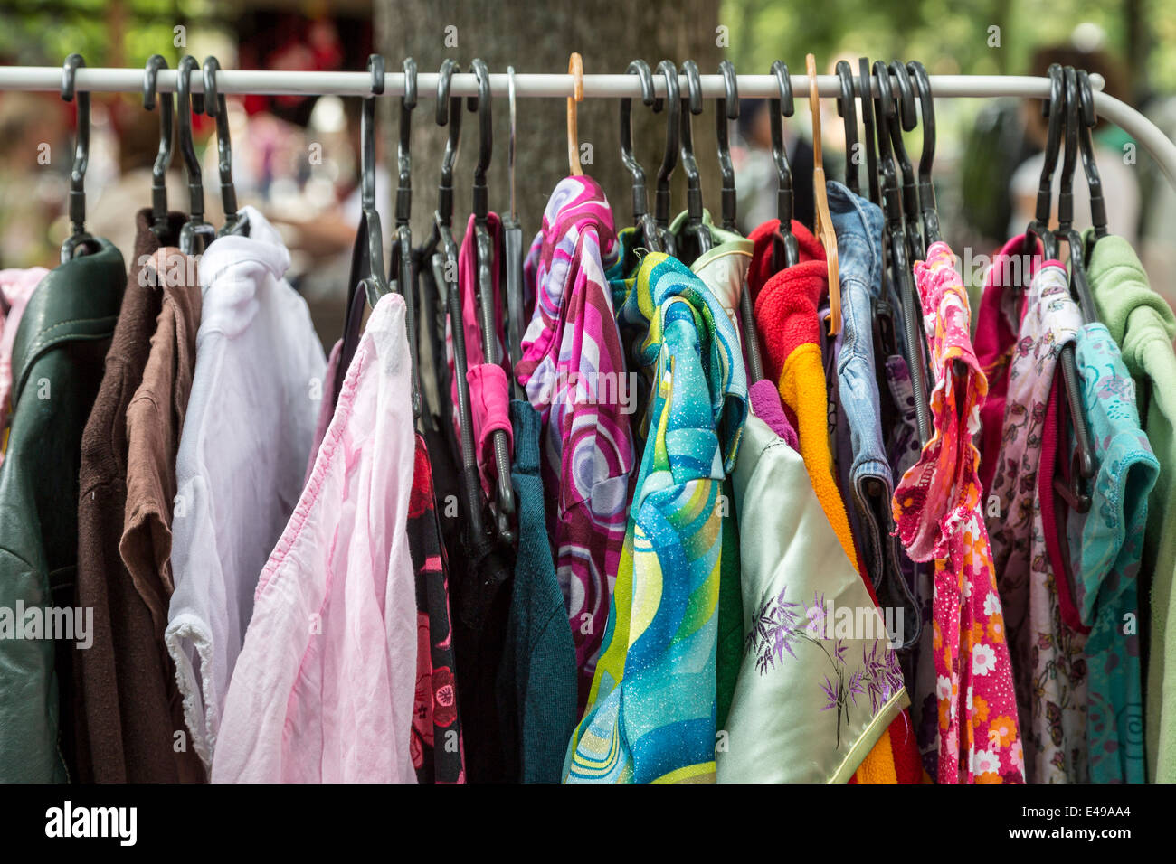 clothes on a rack on a flea market Stock Photo - Alamy
