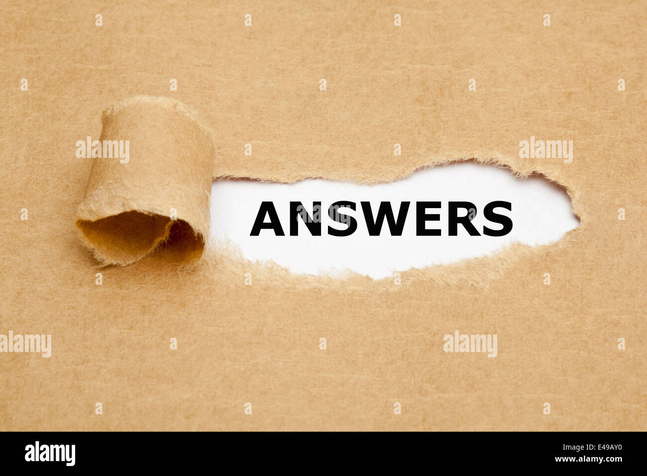 The word Answers appearing behind torn brown paper Stock Photo - Alamy