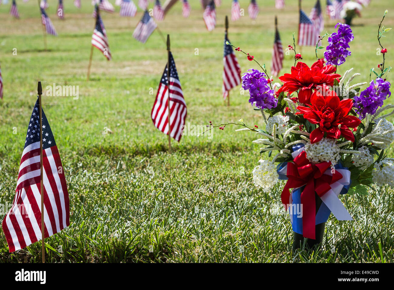 rows of flags on each grave of a Veterans Cemetery in Florida for ...