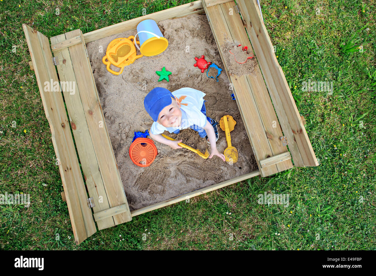 little male child playing in the sandbox Stock Photo - Alamy