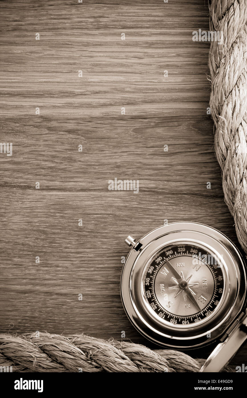 ship ropes and compass at old wooden background Stock Photo - Alamy