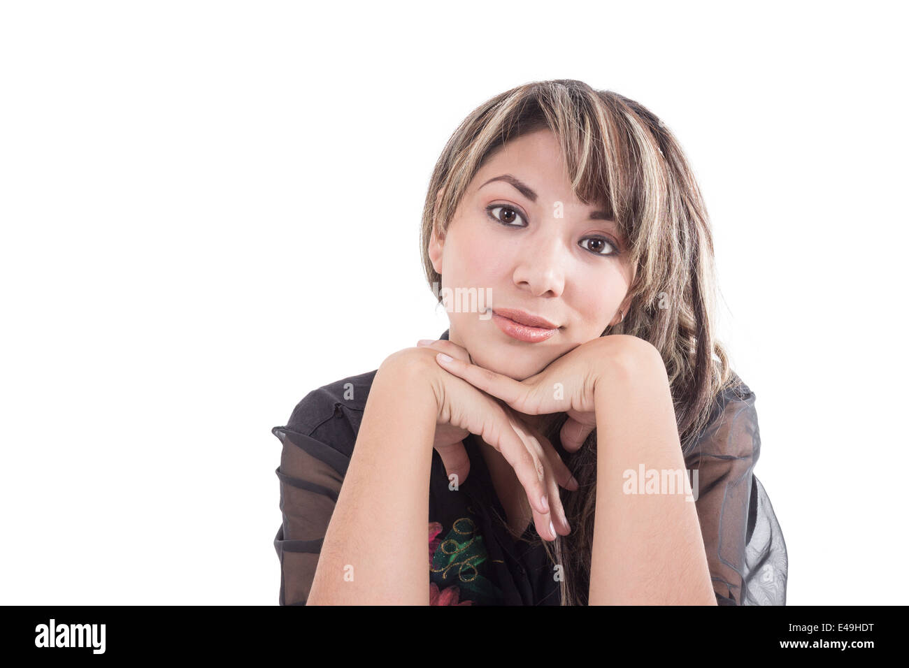 latin girl posing with hands under her face Stock Photo - Alamy