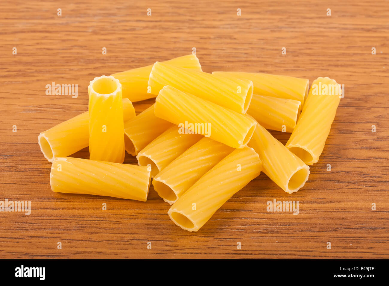 Macaroni on wooden background Stock Photo - Alamy