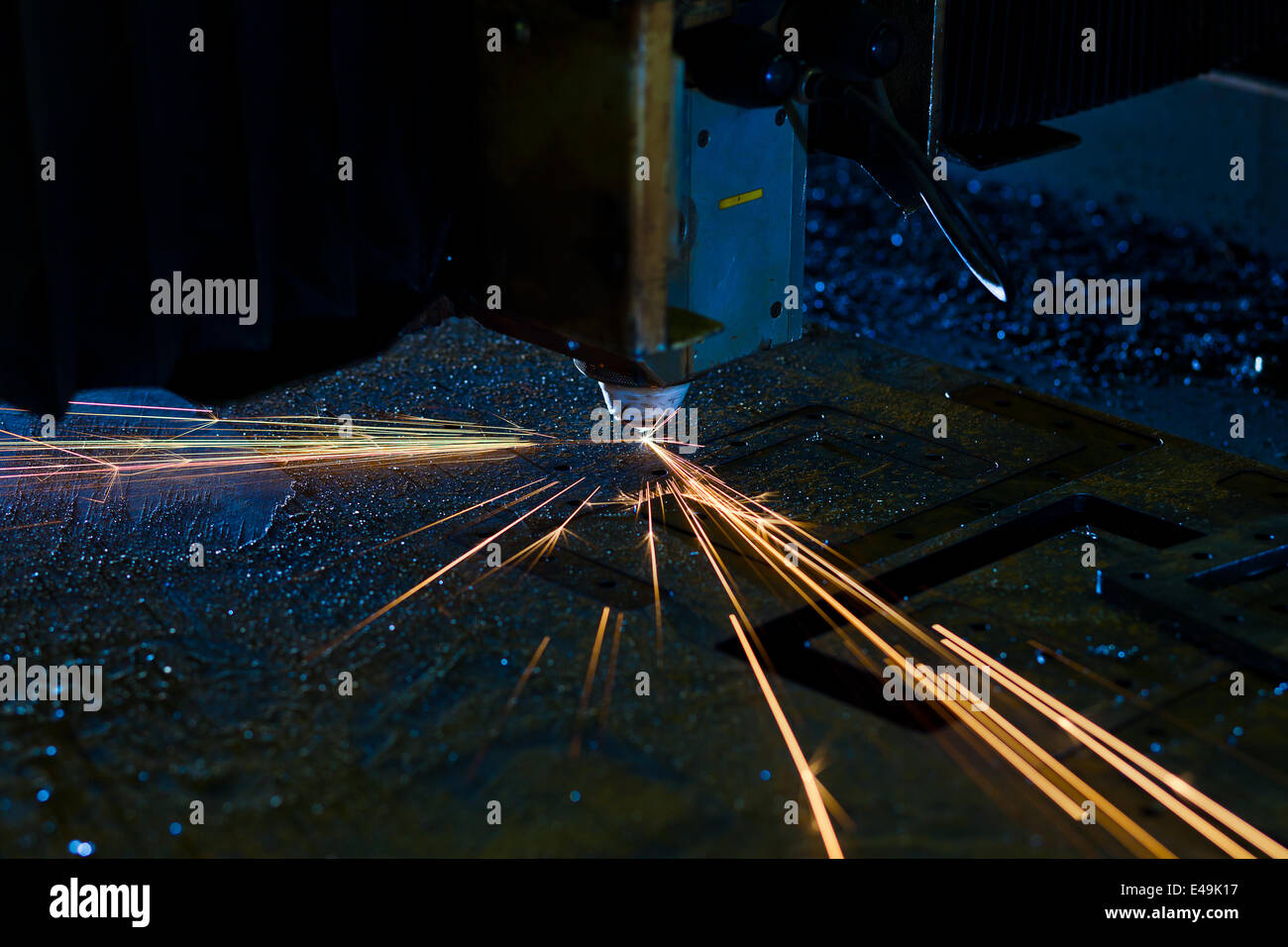 Laser cutting with sparks close up Stock Photo - Alamy