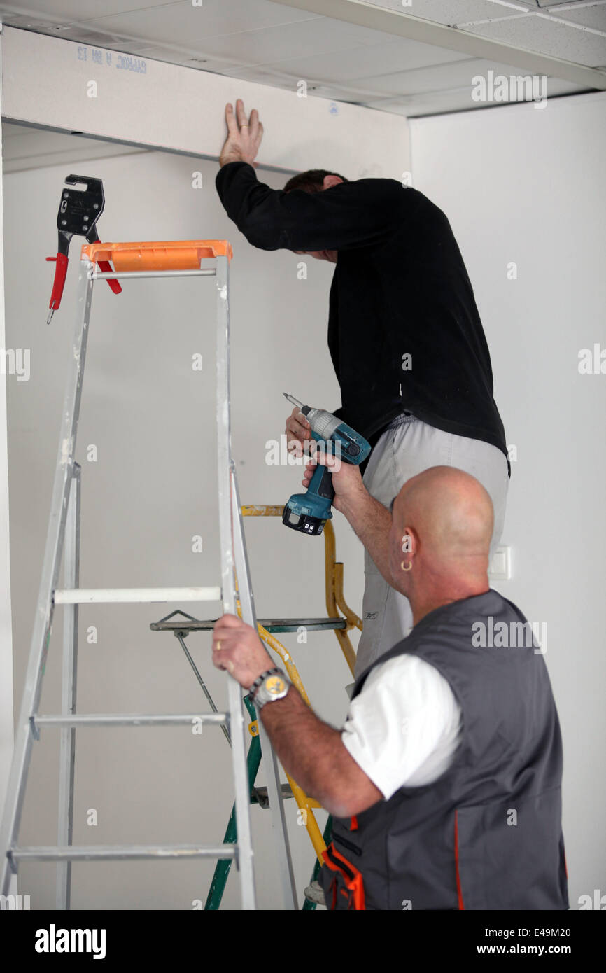 Two electricians working together Stock Photo - Alamy