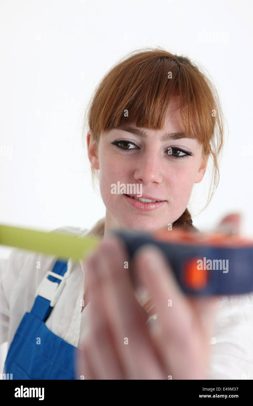 Woman using a measuring tape Stock Photo - Alamy