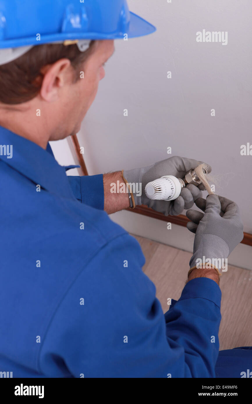 Handyman tightening an adjusting knob Stock Photo - Alamy