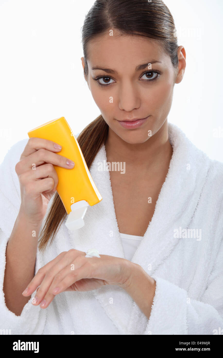 Woman putting on moisturising hi-res stock photography and images - Alamy