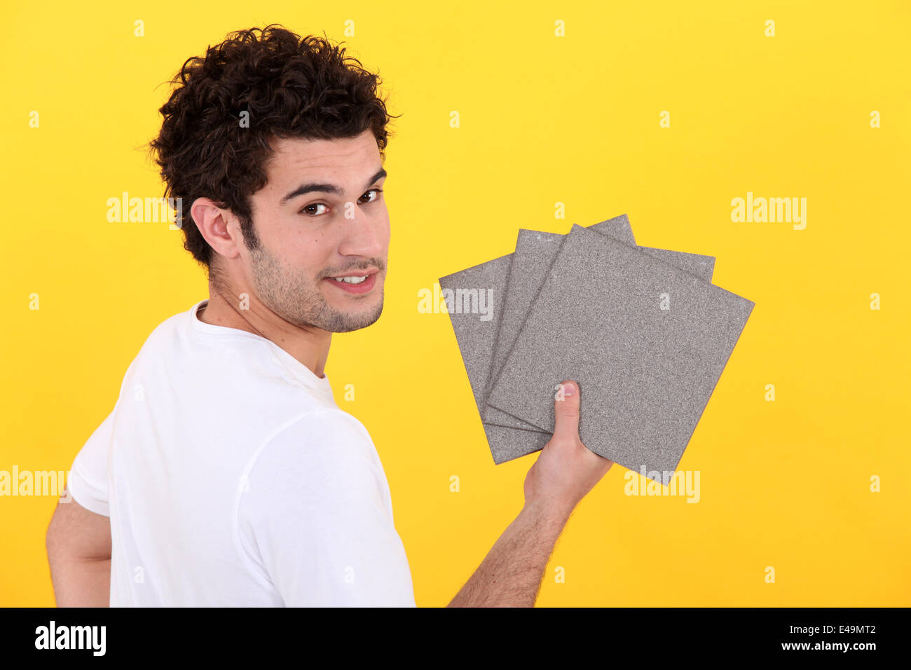 Man holding tiles Stock Photo - Alamy