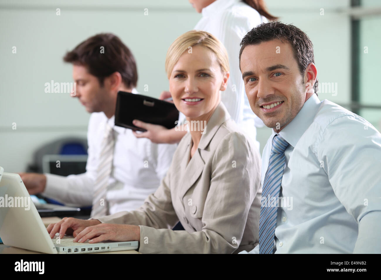 Colleagues working together Stock Photo - Alamy
