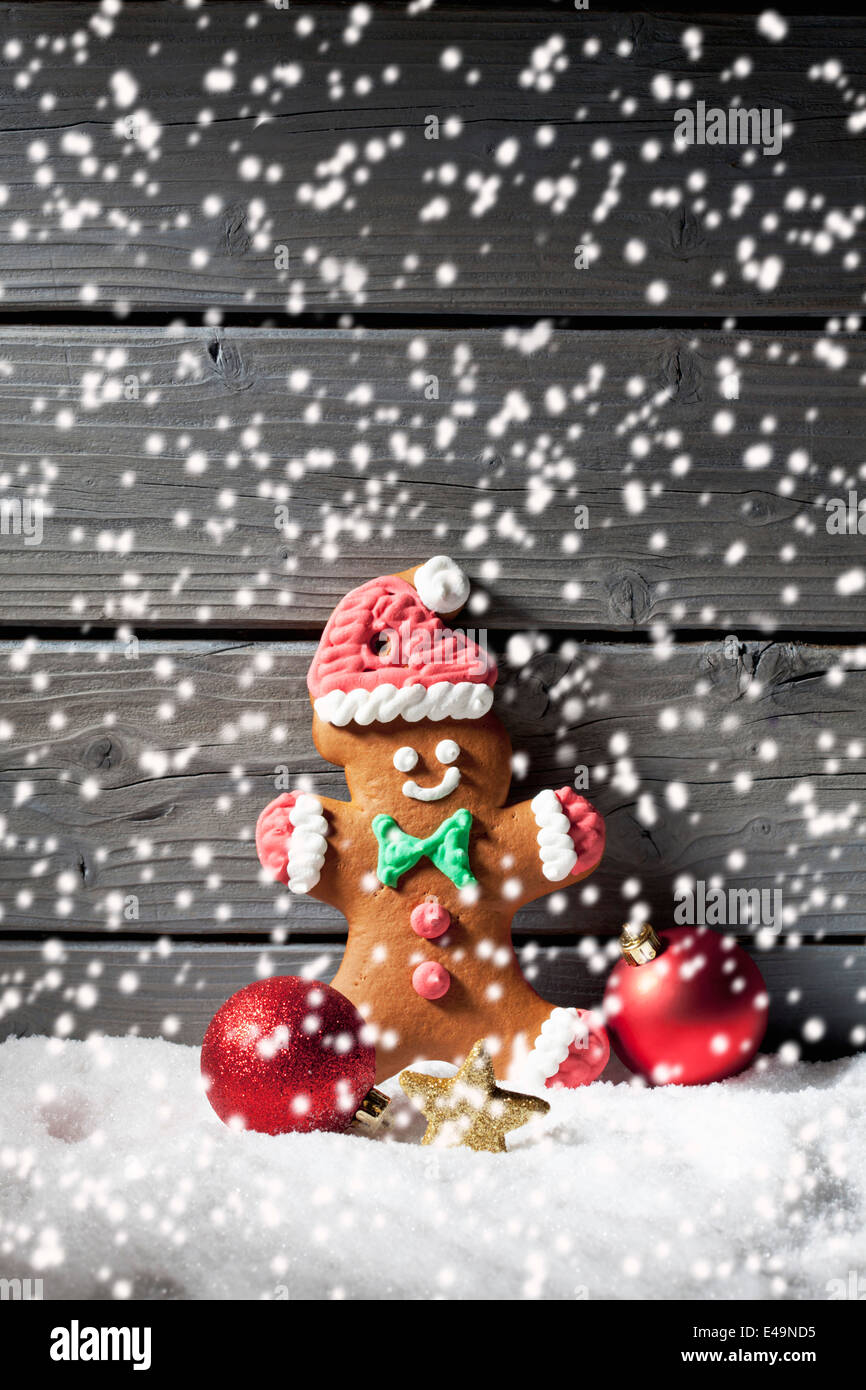 Gingerbread man and Christmas bubbles with rippling artificial snow in ...