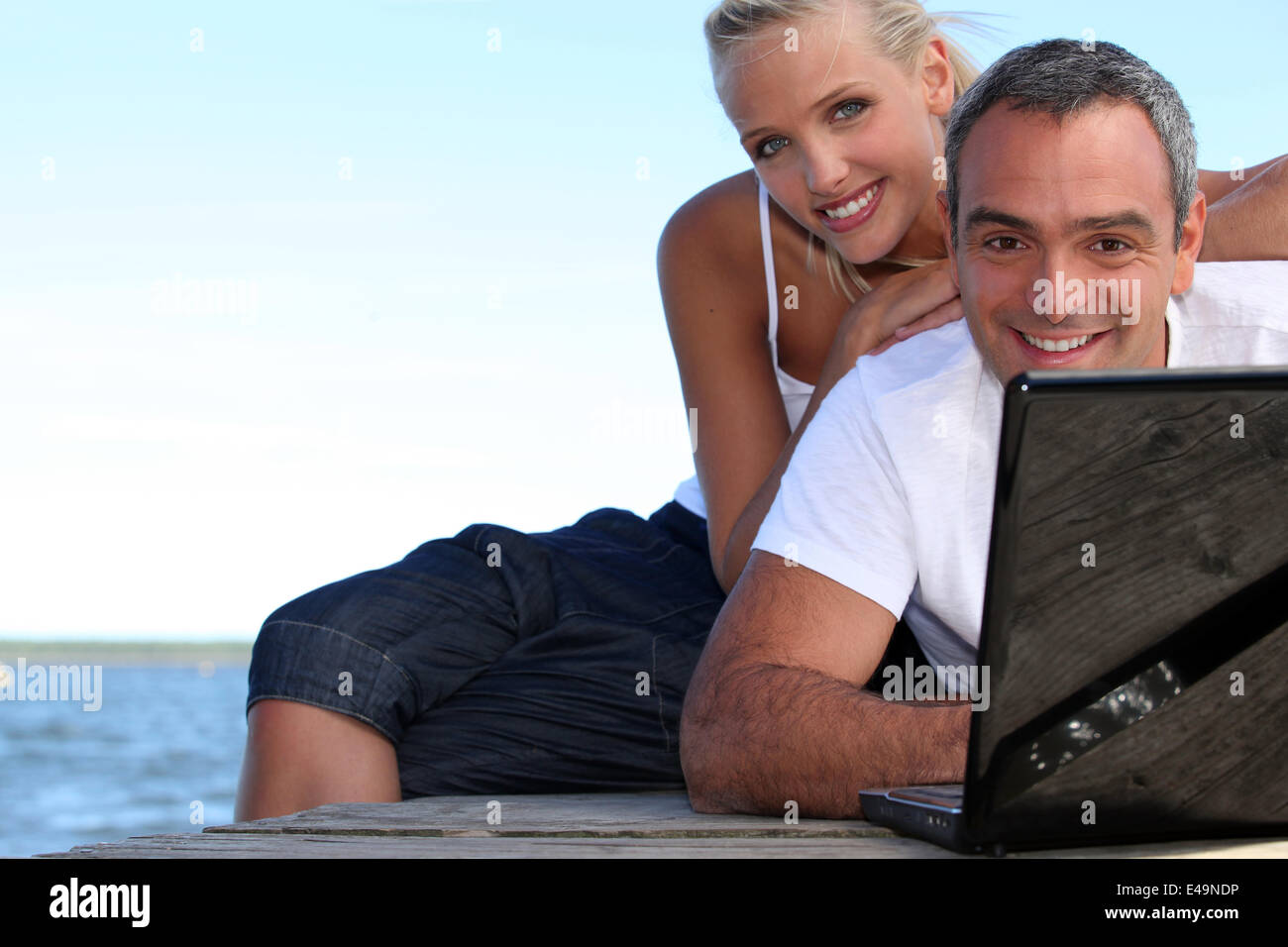 a couple on a pontoon near the sea Stock Photo - Alamy