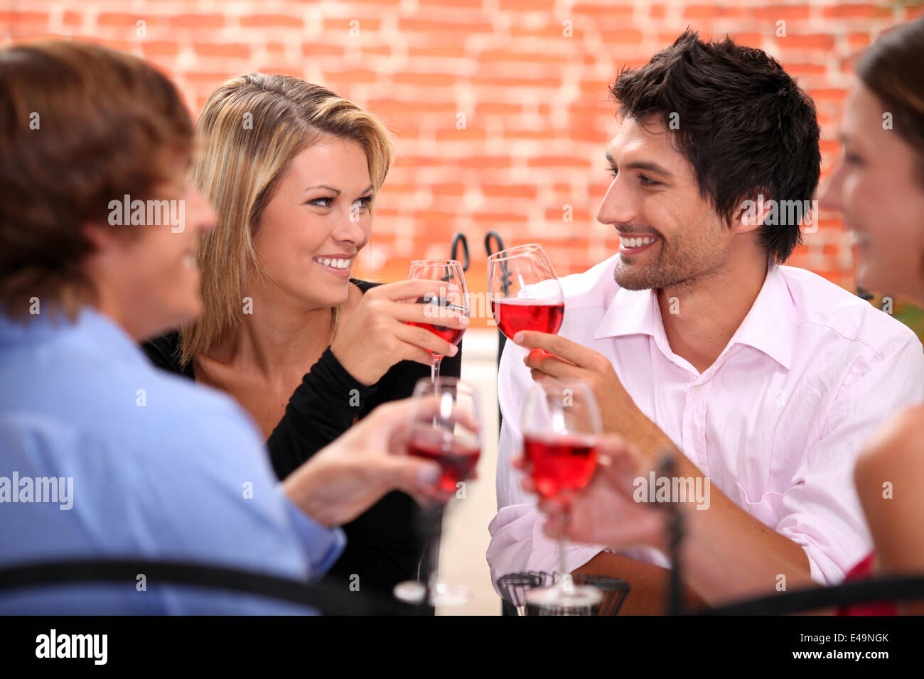 Four friends drinking in restaurant Stock Photo - Alamy