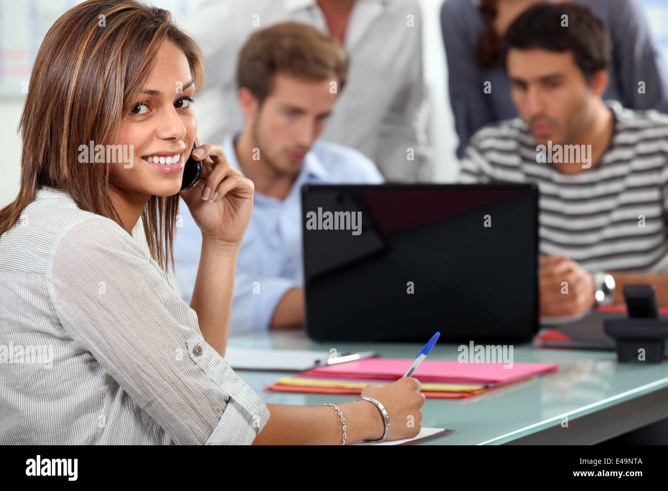 Young people with a laptop and cellphone Stock Photo - Alamy