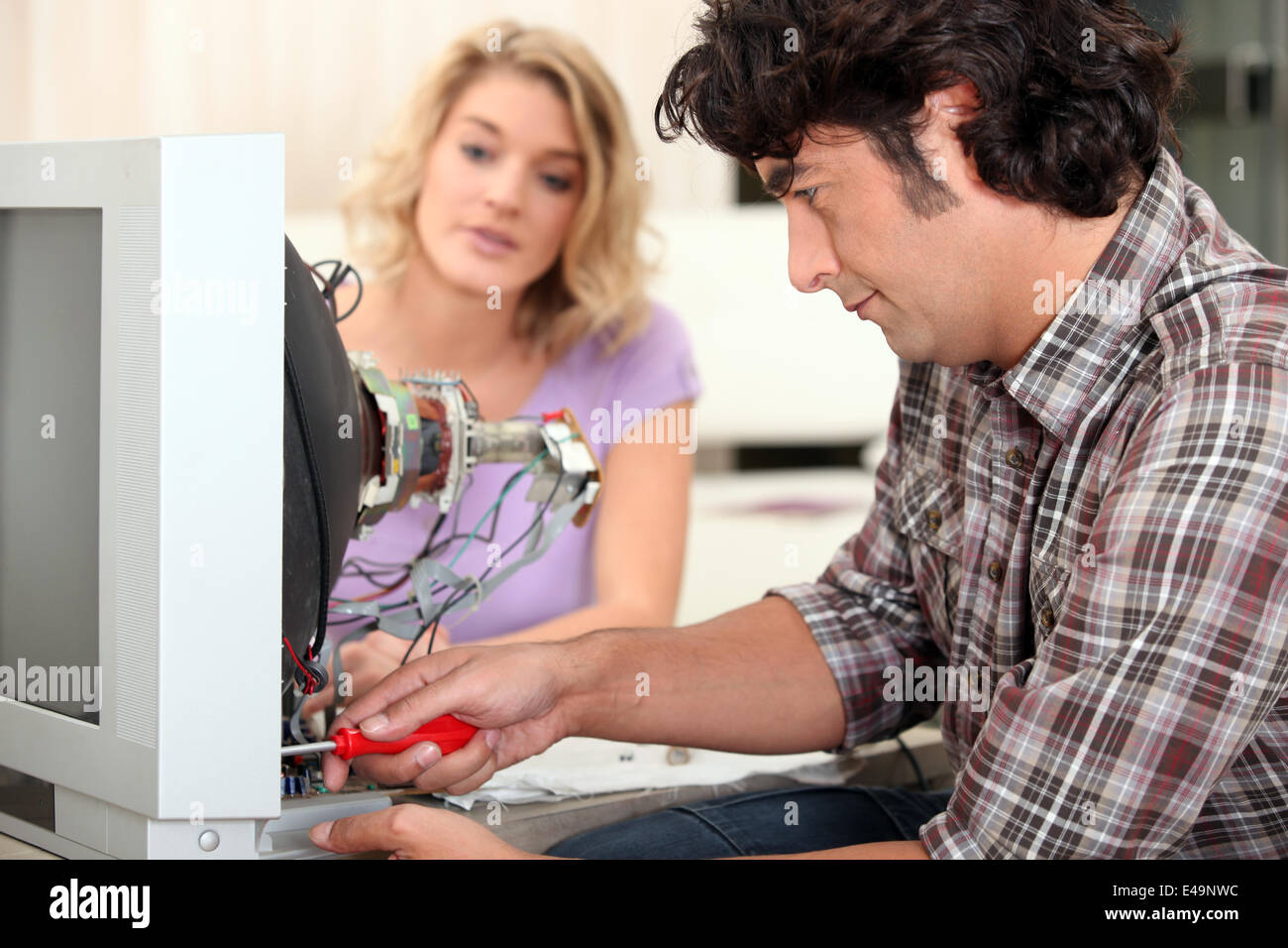 Man fixing television Stock Photo - Alamy