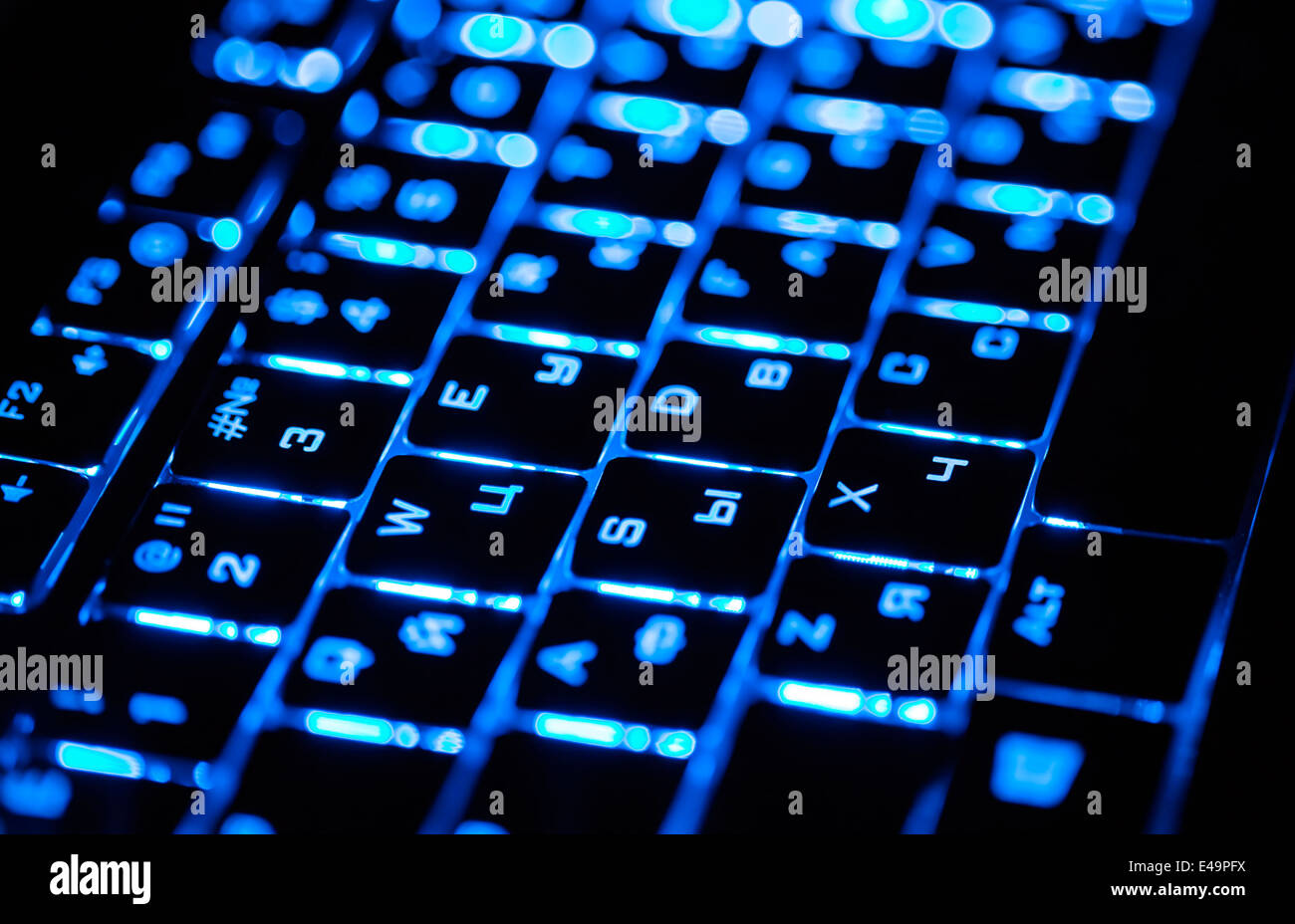 Blue lighting keyboard in the dark closeup Stock Photo - Alamy