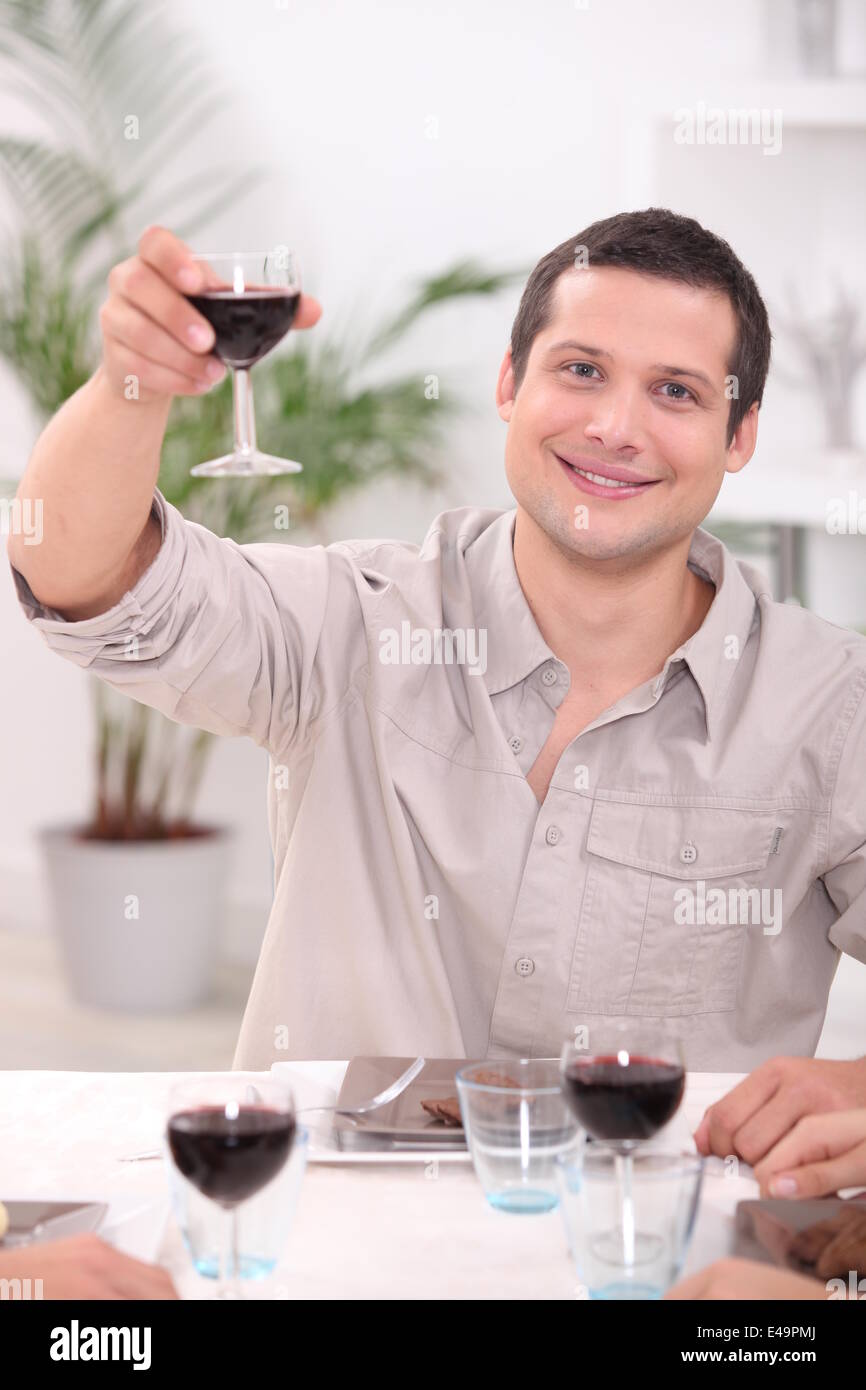 Man raising his glass for a toast Stock Photo - Alamy