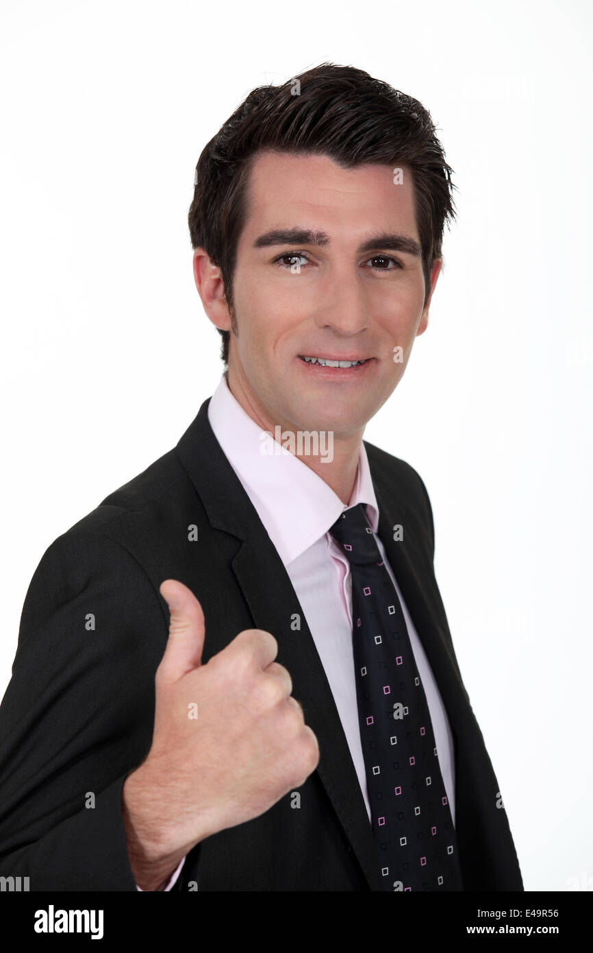 Smiling businessman giving the thumb's up Stock Photo - Alamy