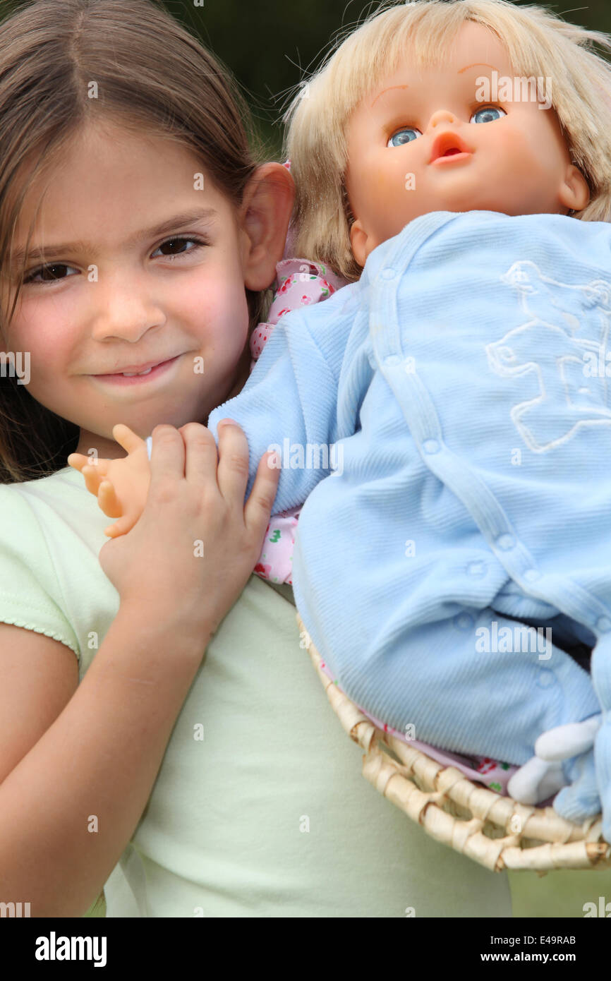 Little girl playing with doll Stock Photo - Alamy