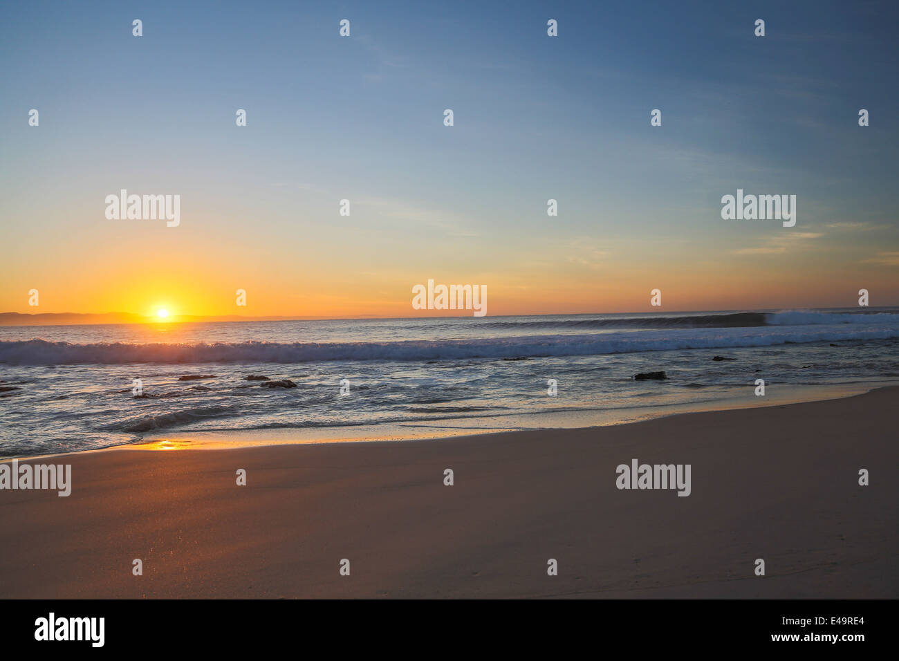 A right hand wave breaking in the sea as the sun rises for the start of ...