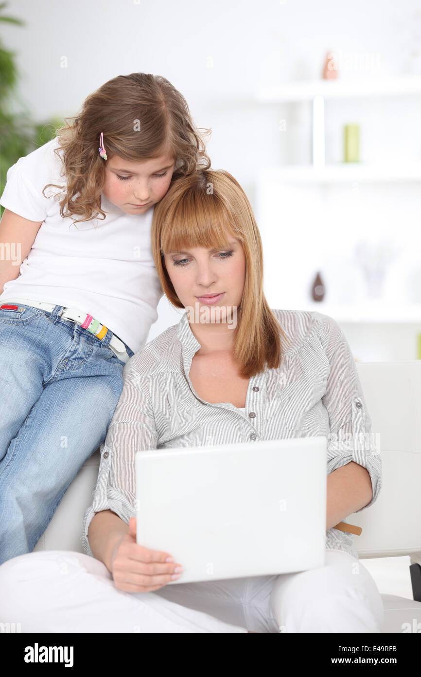 Mother and daughter with laptop Stock Photo - Alamy