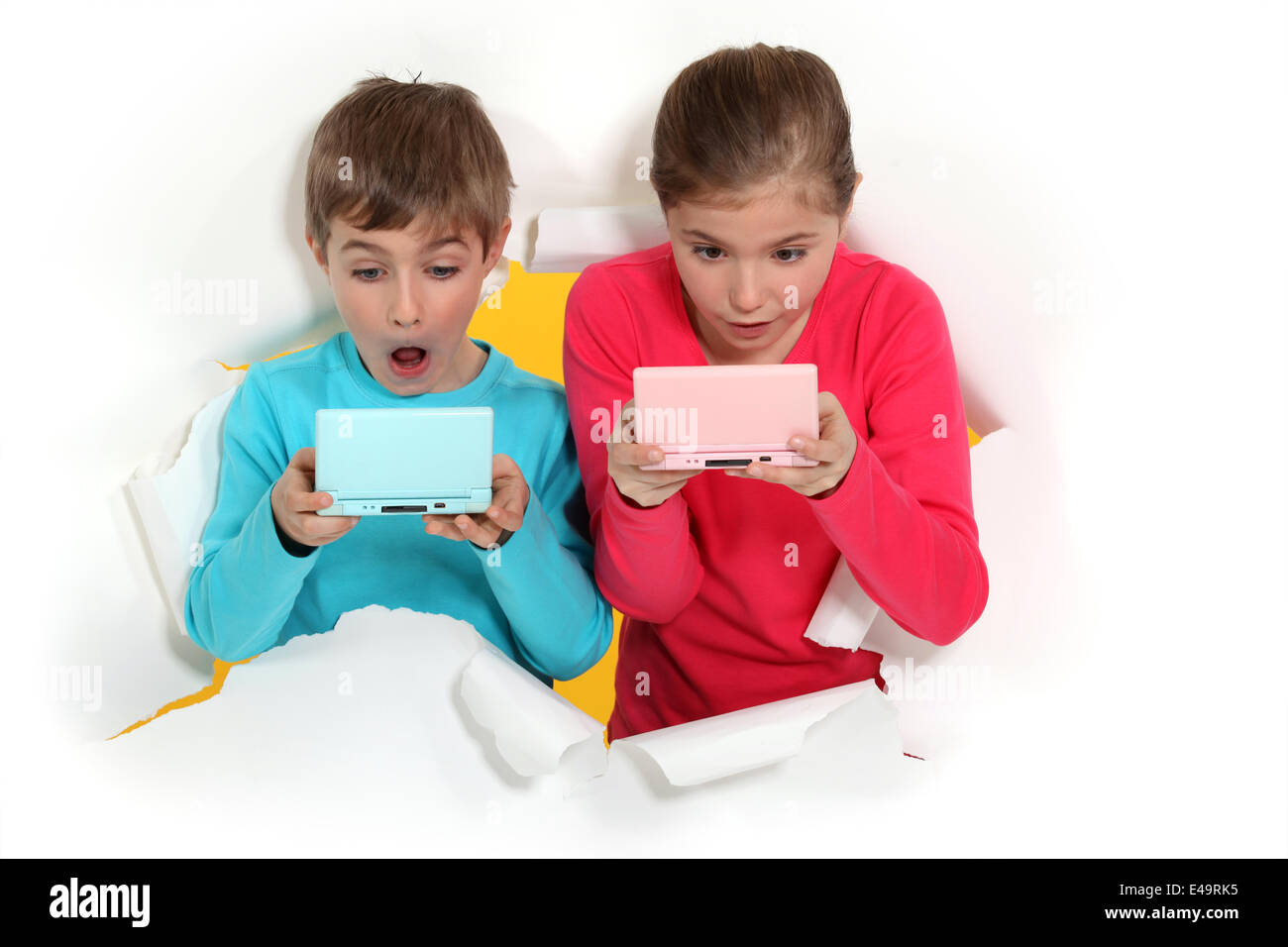 Children playing handheld computer games Stock Photo - Alamy