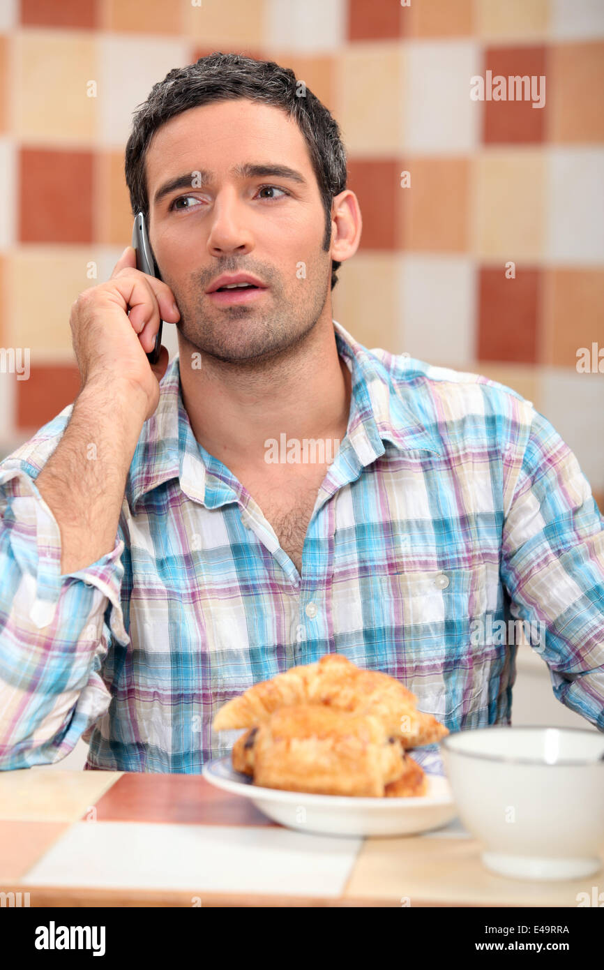 Man taking a call at breakfast Stock Photo - Alamy