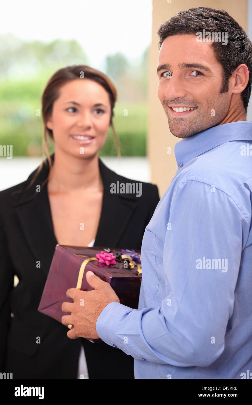 Man offering gift to woman Stock Photo - Alamy