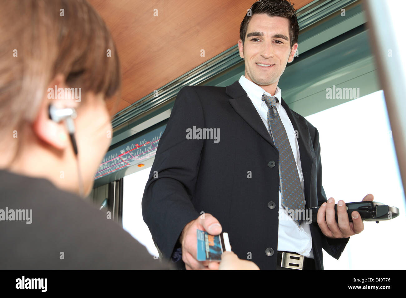 Tram conductor checking ticket Stock Photo - Alamy
