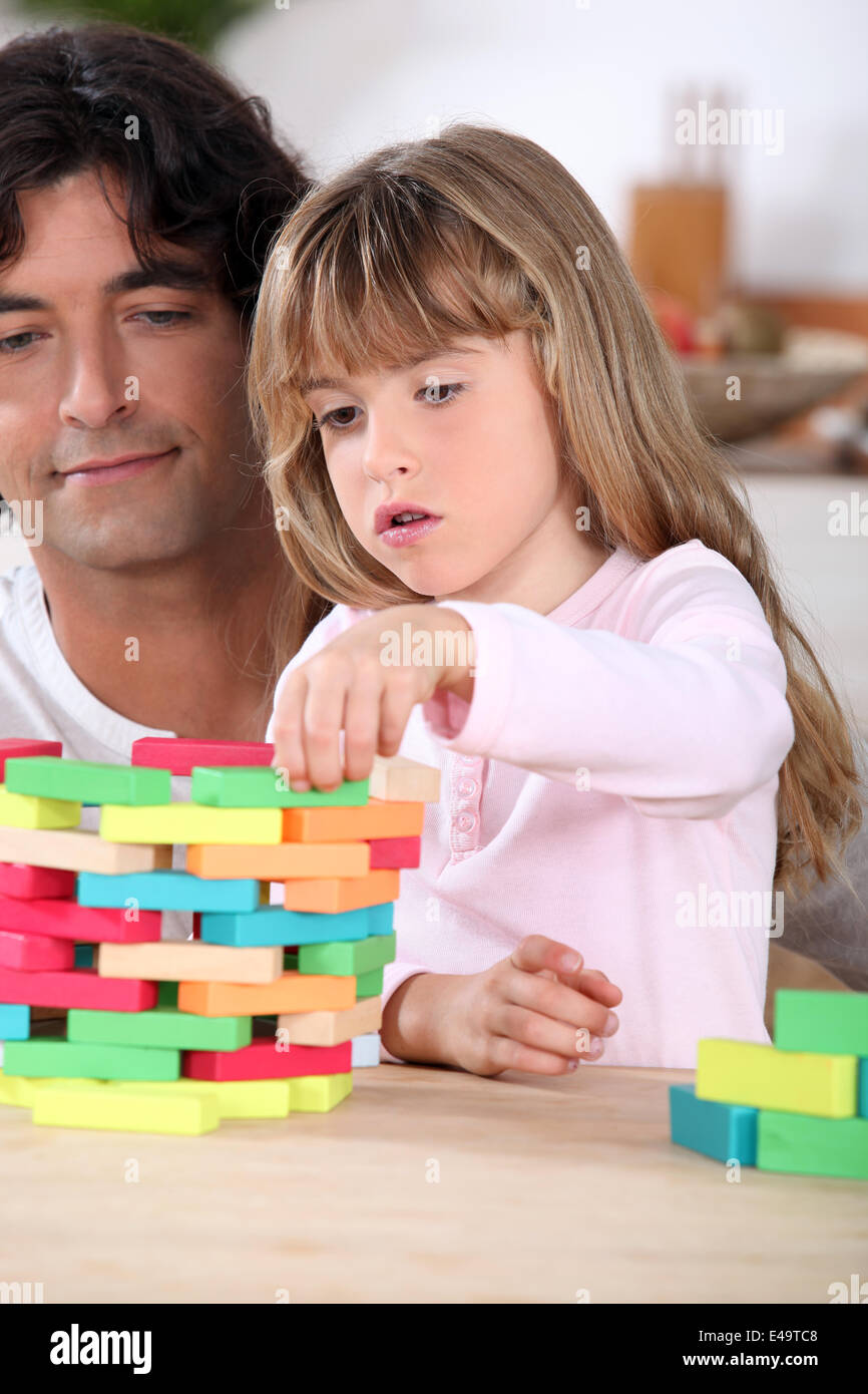 Father and daughter playing a game at home Stock Photo - Alamy