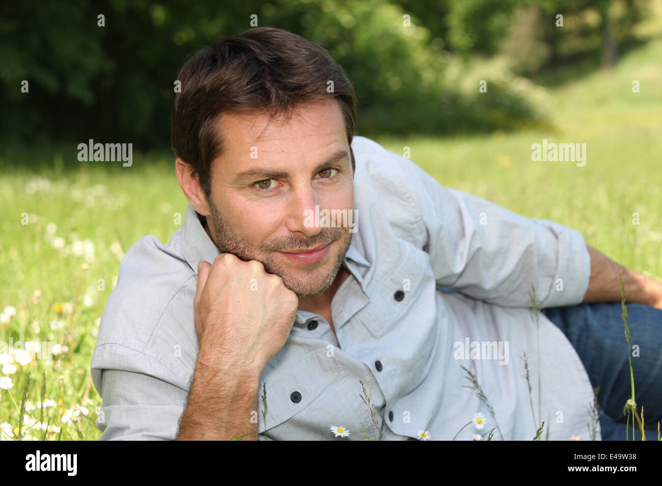 Man laying in park Stock Photo - Alamy