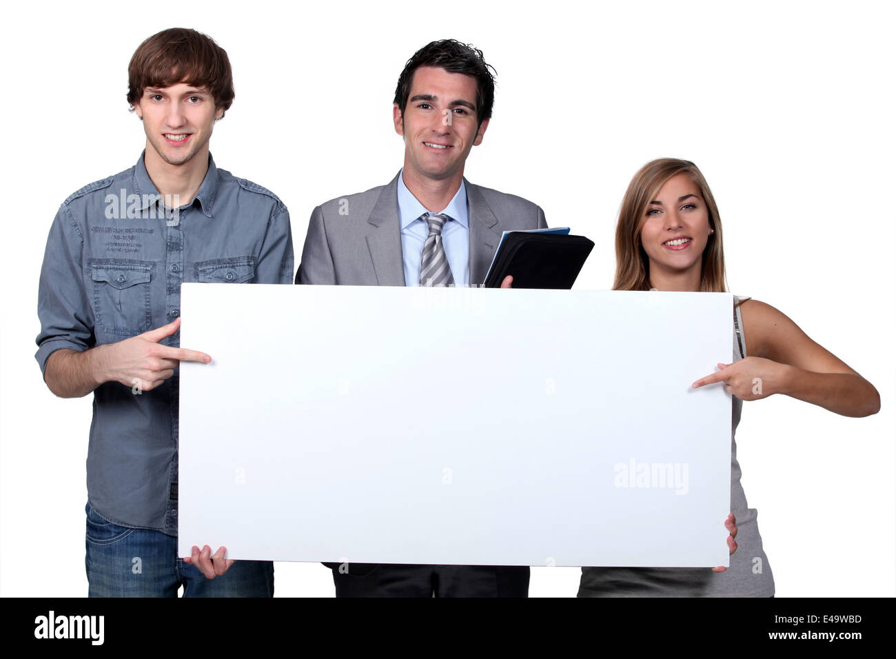 Young people pointing at blank board Stock Photo - Alamy