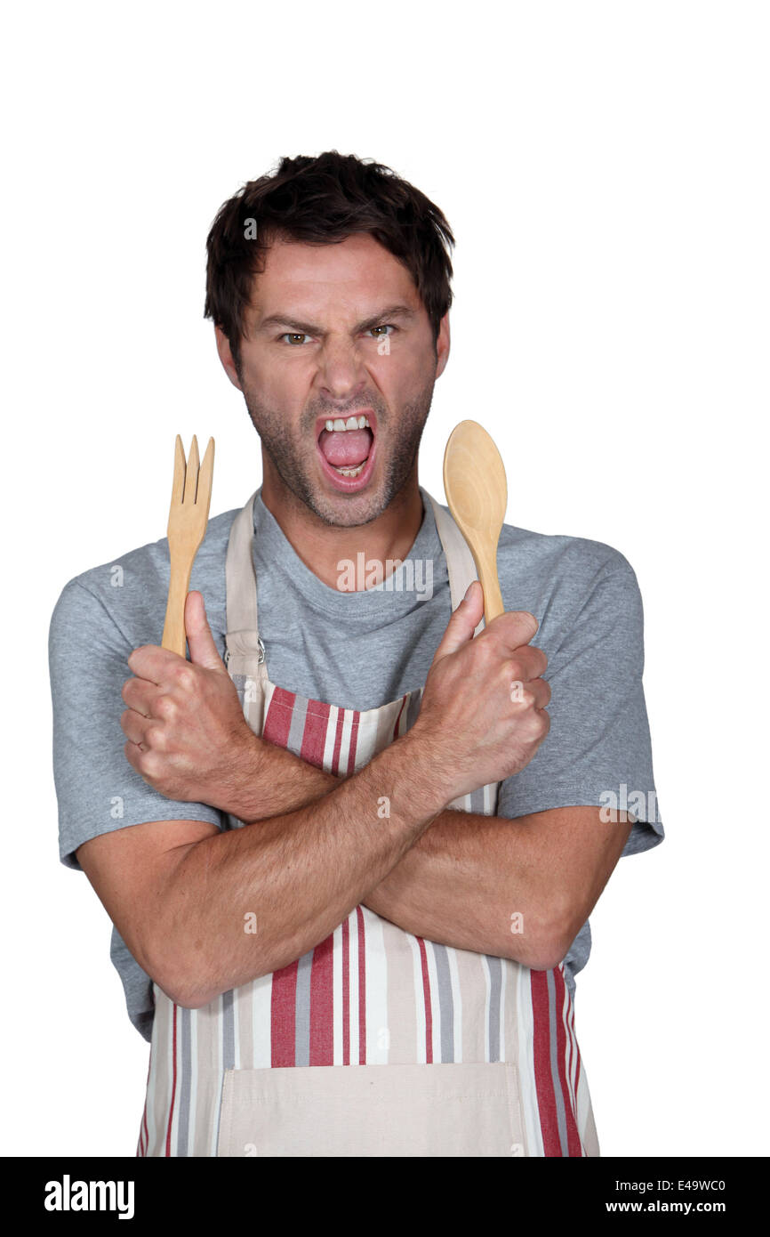 Aggressive cook in apron Stock Photo - Alamy