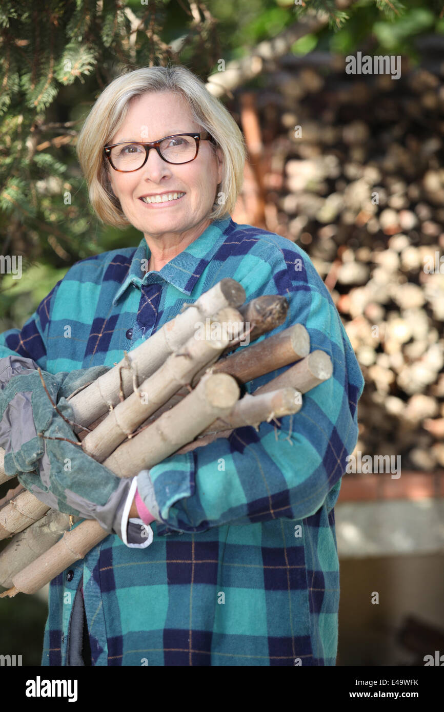 Woman collecting wood in the forest Stock Photo - Alamy