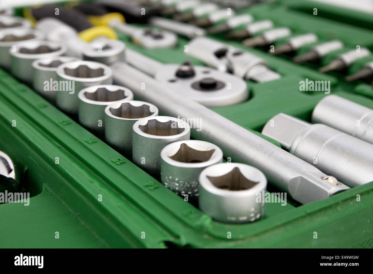 Set of metal tools in green container Stock Photo - Alamy