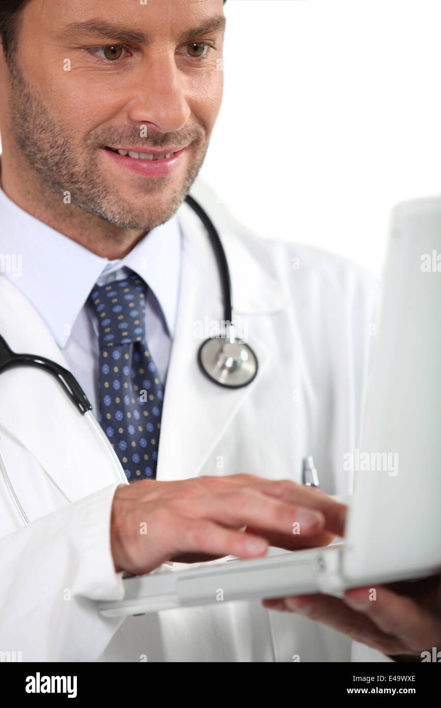 A doctor looking at his laptop Stock Photo - Alamy